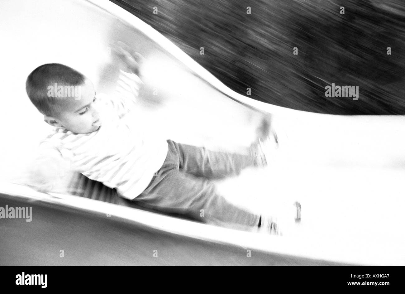 Small boy sliding down the slide Stock Photo - Alamy