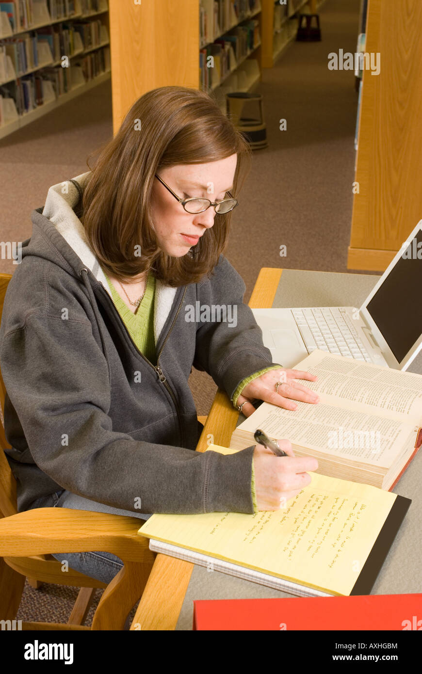 a young woman studies in the library Stock Photo - Alamy