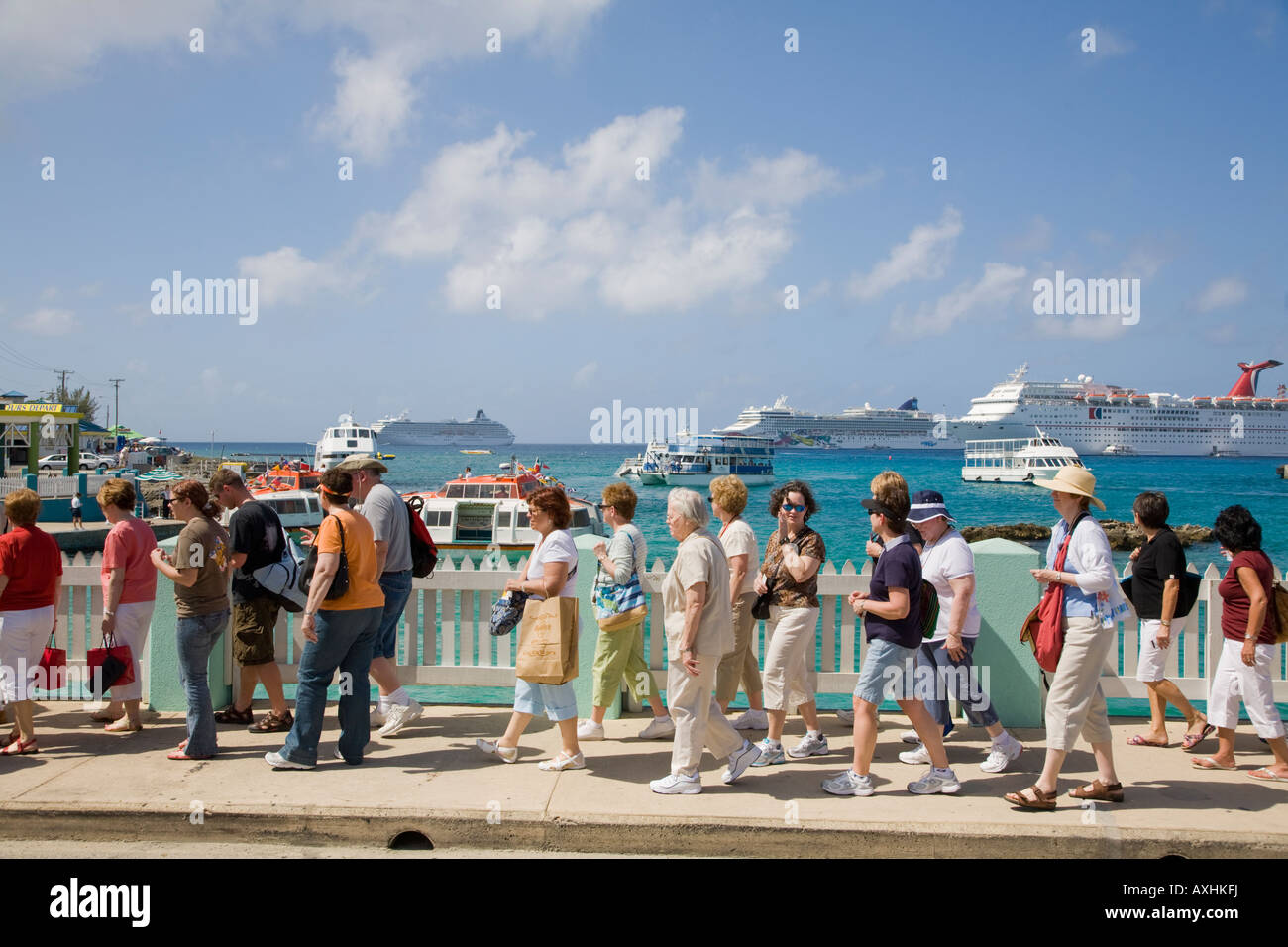 Cruise ship passengers walking in Georgetown waterfront with cruise ...