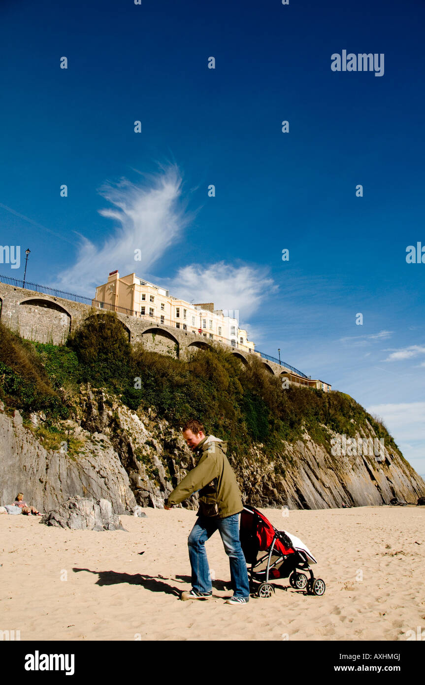 Young father with buggy South Beach Tenby Pembrokeshire Wales UK on a ...