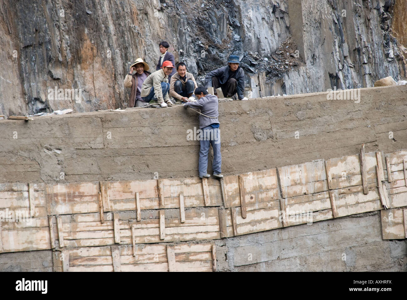 Road workers in the mountains of Yunnan often work under dangerous ...
