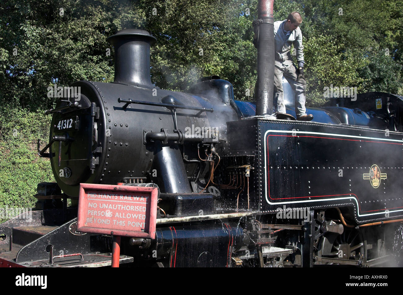 Ivatt Class 2 2-6-2 tank engine takes water at Ropley station, Mid ...
