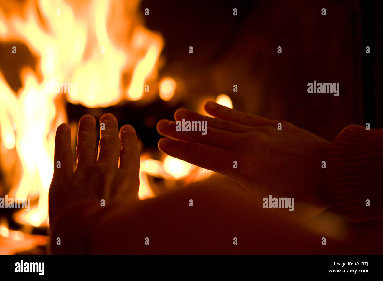 Person warming their hands over a fire Stock Photo - Alamy