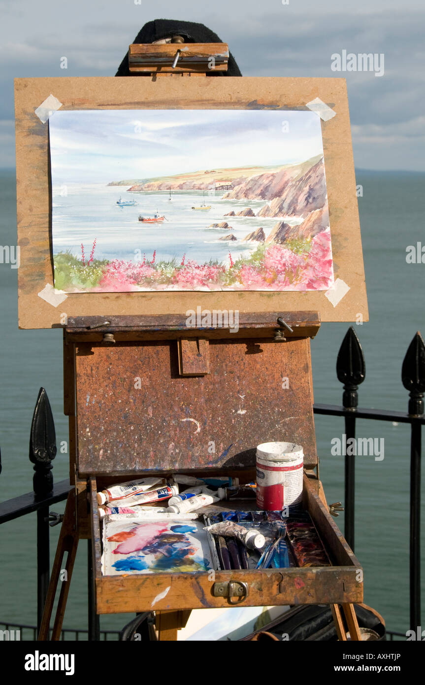 A Watercolour painting of the pembrokeshire coast on an easel at Tenby ...