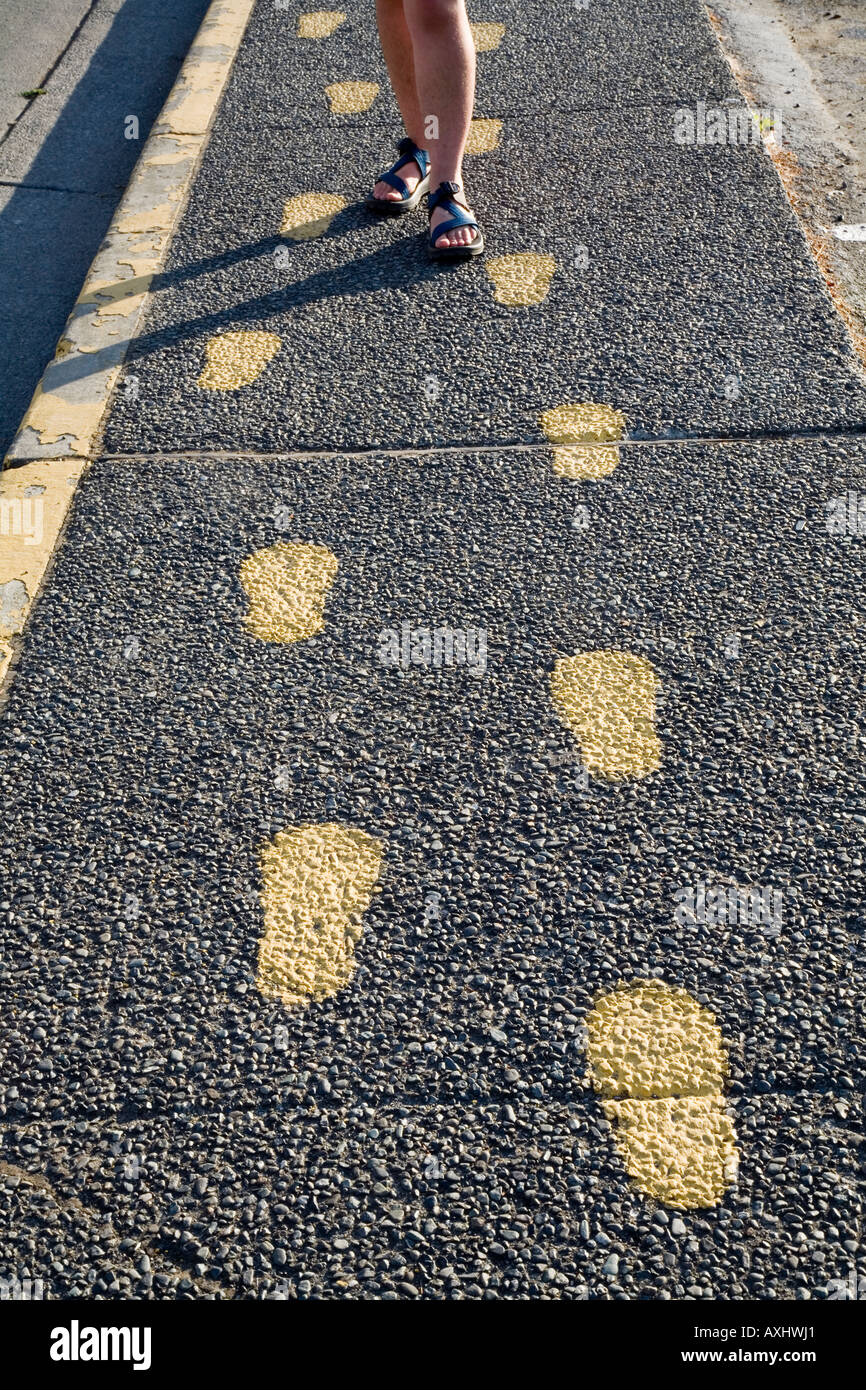 Yellow footprints on sidewalk hi-res stock photography and images - Alamy
