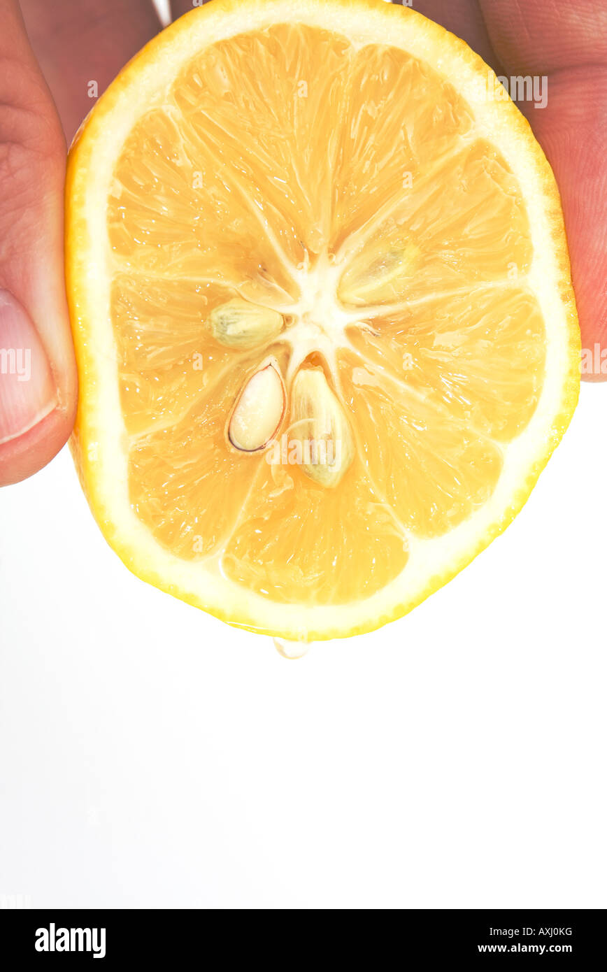 hand squeezing lemon isolated against white background Stock Photo - Alamy