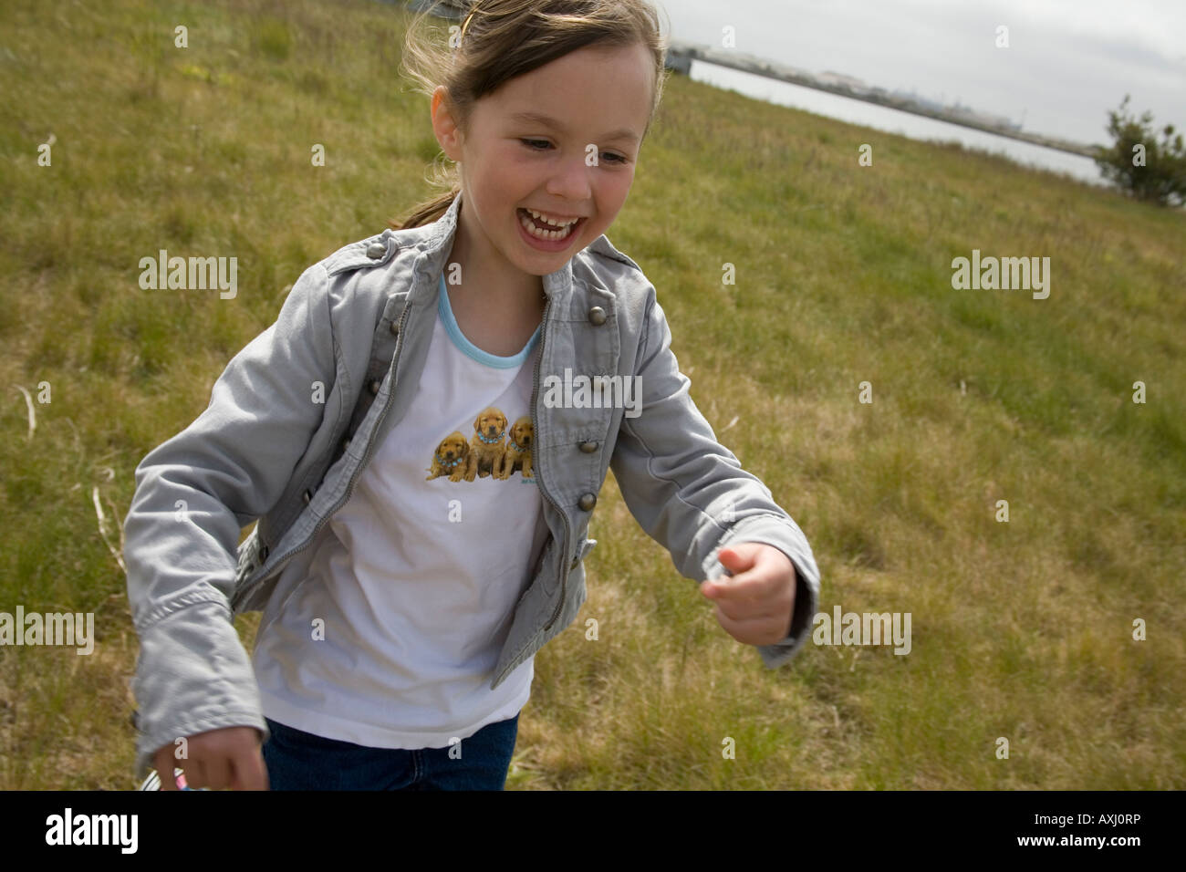 happy girl running through tall grass Stock Photo - Alamy