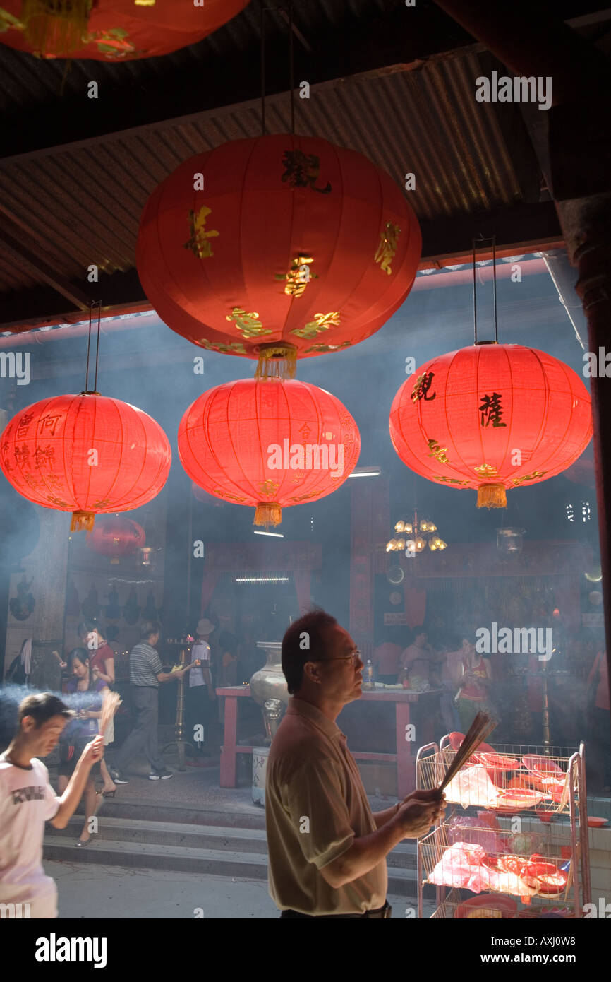 Worshipers make offerings and prayers at Goddess of Mercy Temple at ...