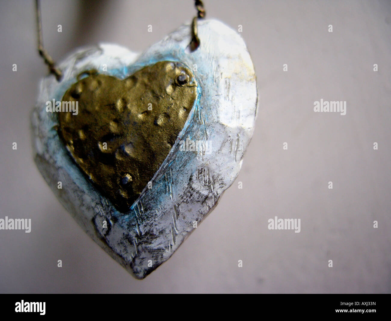 Small grungy looking heart against a light background Stock Photo - Alamy