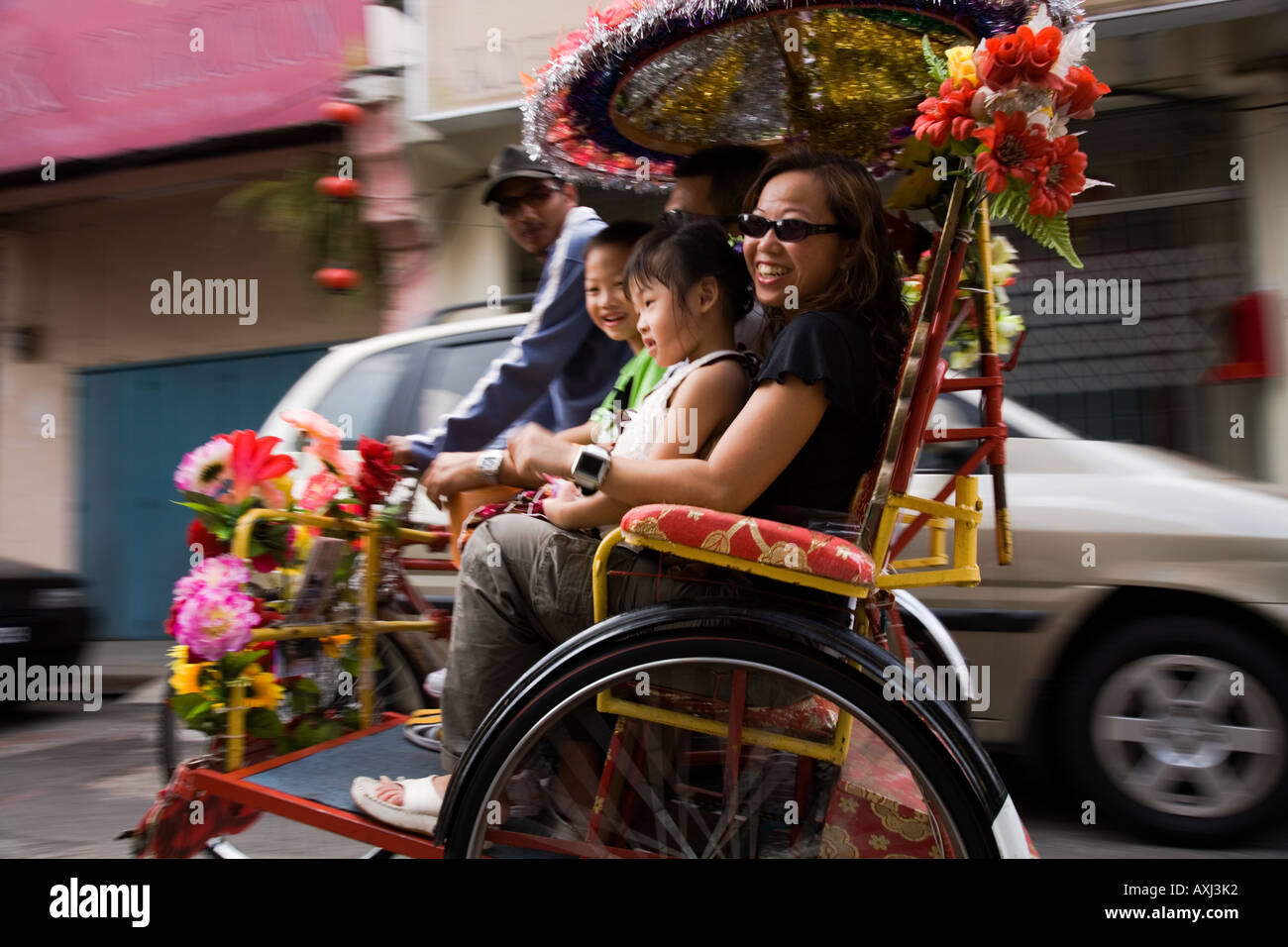 Tourists enjoy a ride around town in a Malaysian Trishaw cycle. Melaka ...