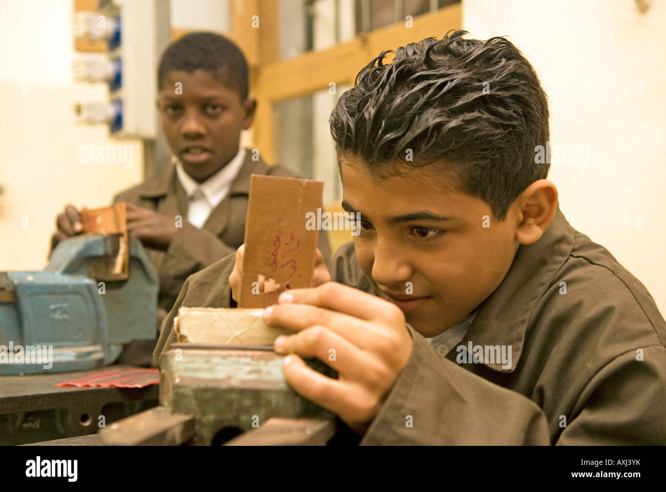 Young boy pupils engaged in copper workshop at the Islamic Arts and ...