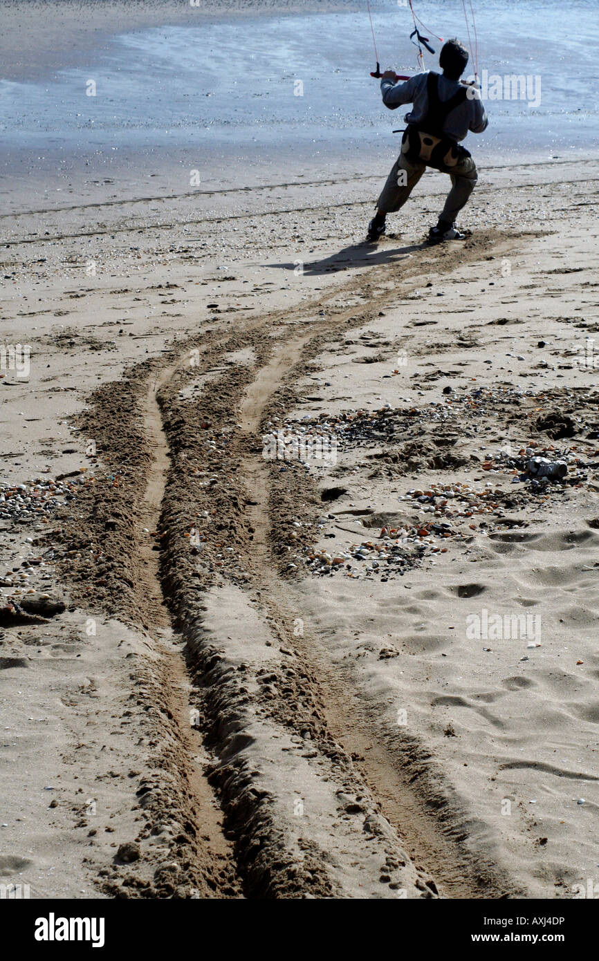 Man being dragged along a beach by his surfing kite Stock Photo - Alamy