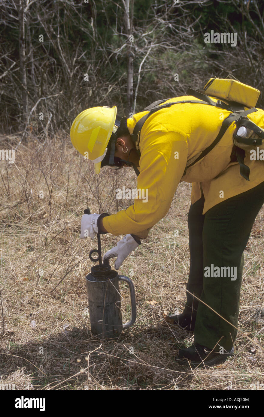 Filling drip torches to be used to set controlled fire Stock Photo - Alamy