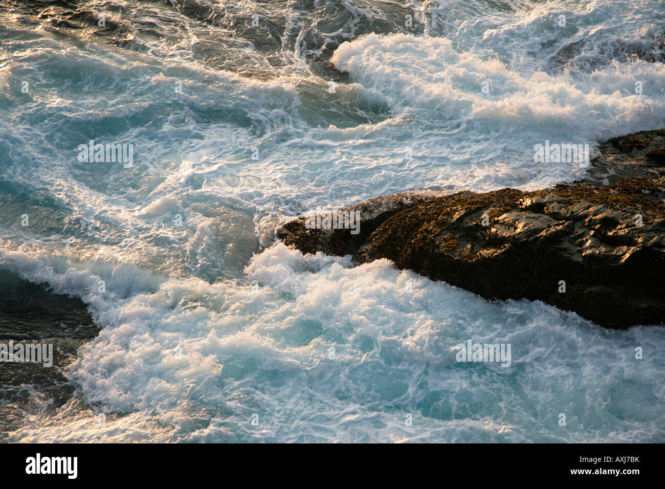 white waves hitting rocks Stock Photo - Alamy