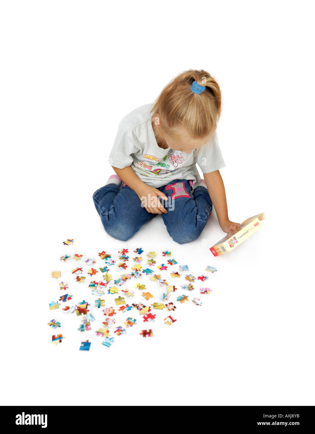Little girl playing puzzles Stock Photo - Alamy