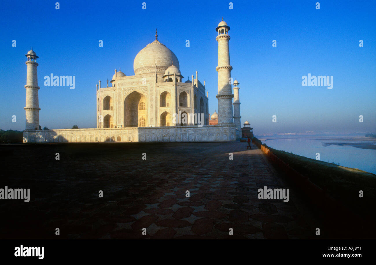 side view of Taj Mahal, with tiled foreground and river at back of the ...