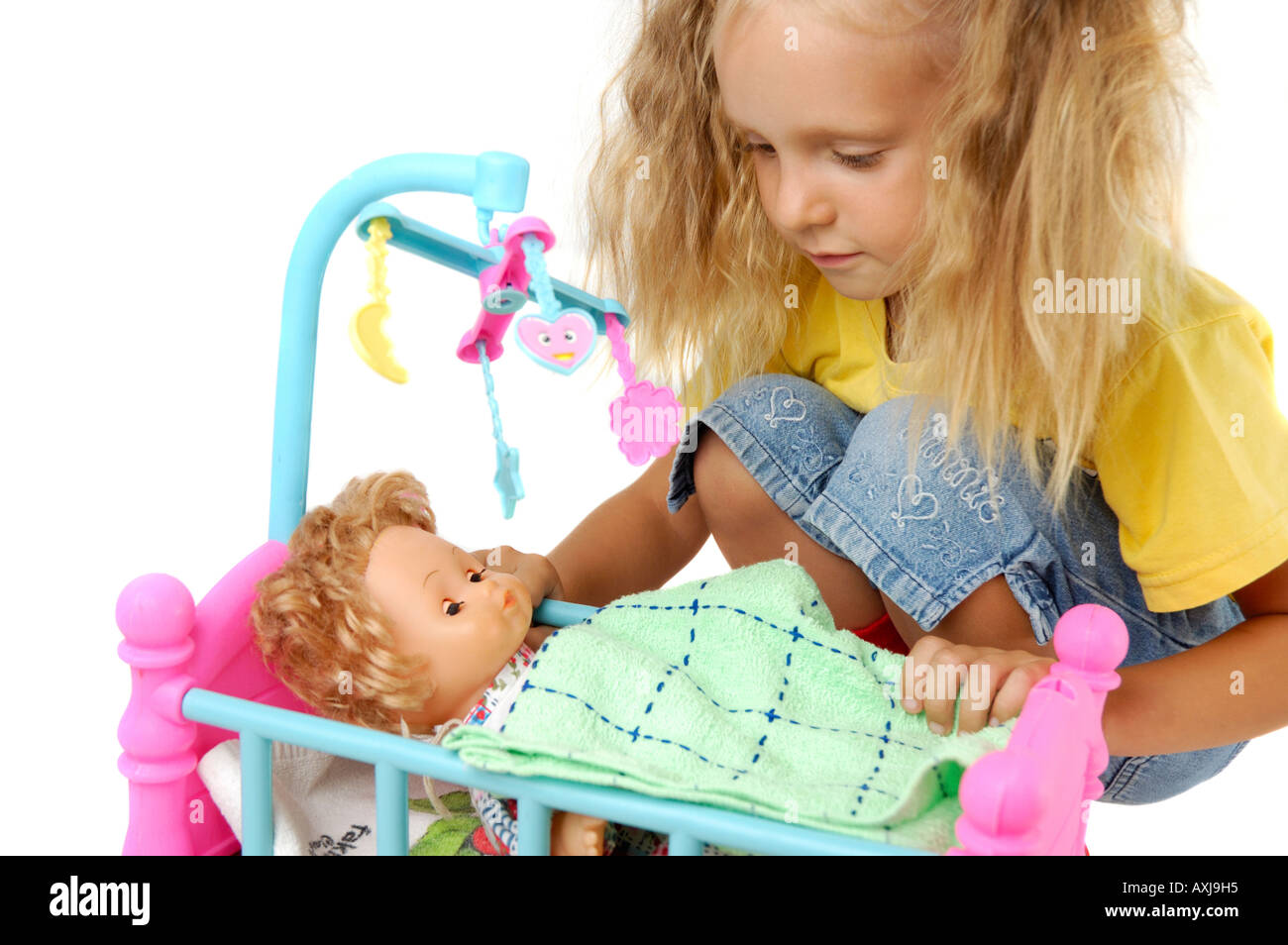 Cute little girl singing lullaby to her doll Stock Photo - Alamy