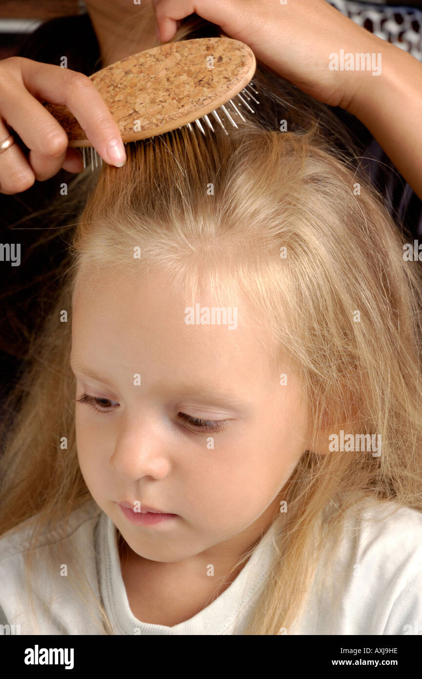 Little girl with untidy hair being combed Stock Photo - Alamy