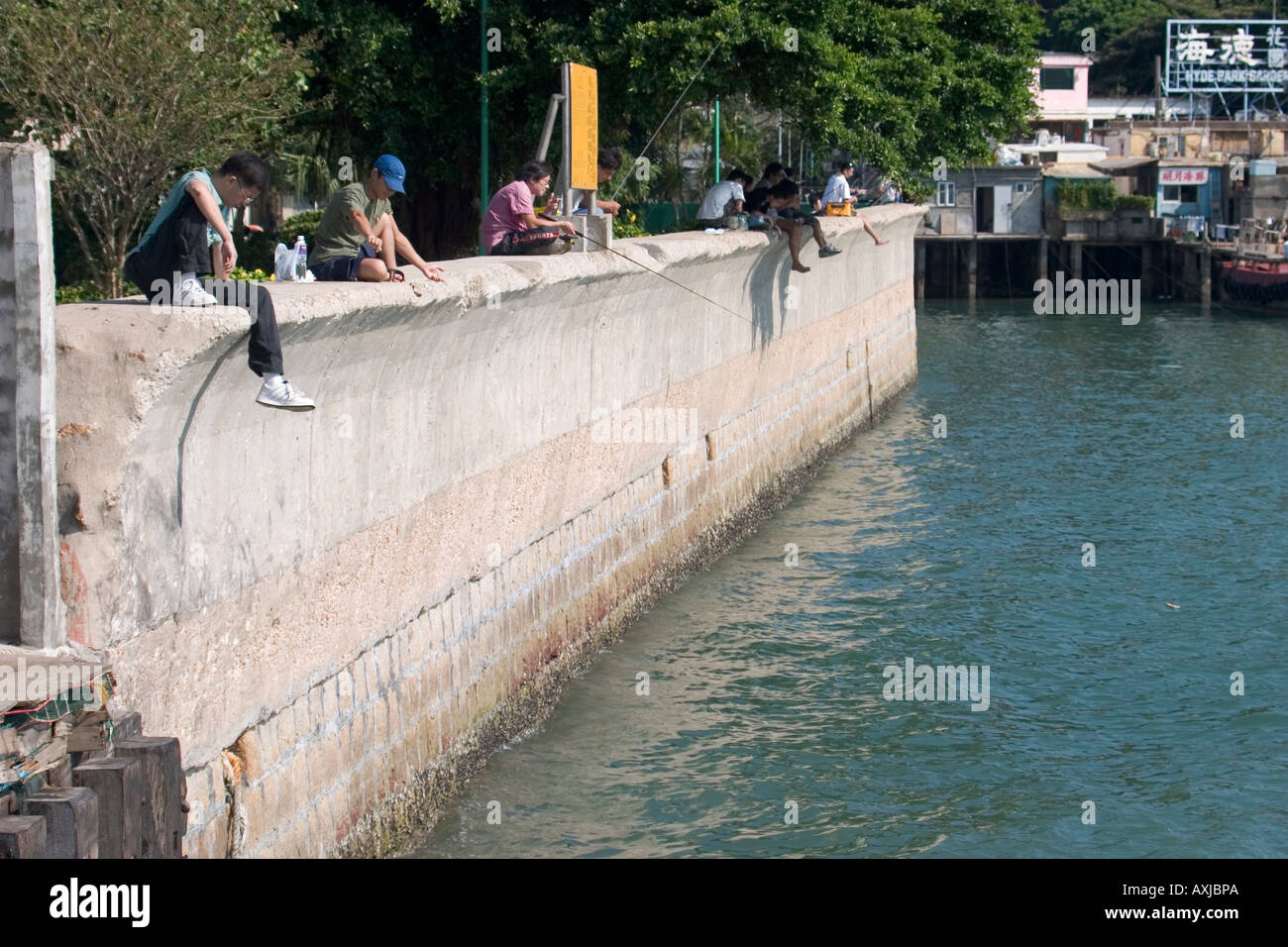 Recreational fishing from Sea Wall Stock Photo - Alamy