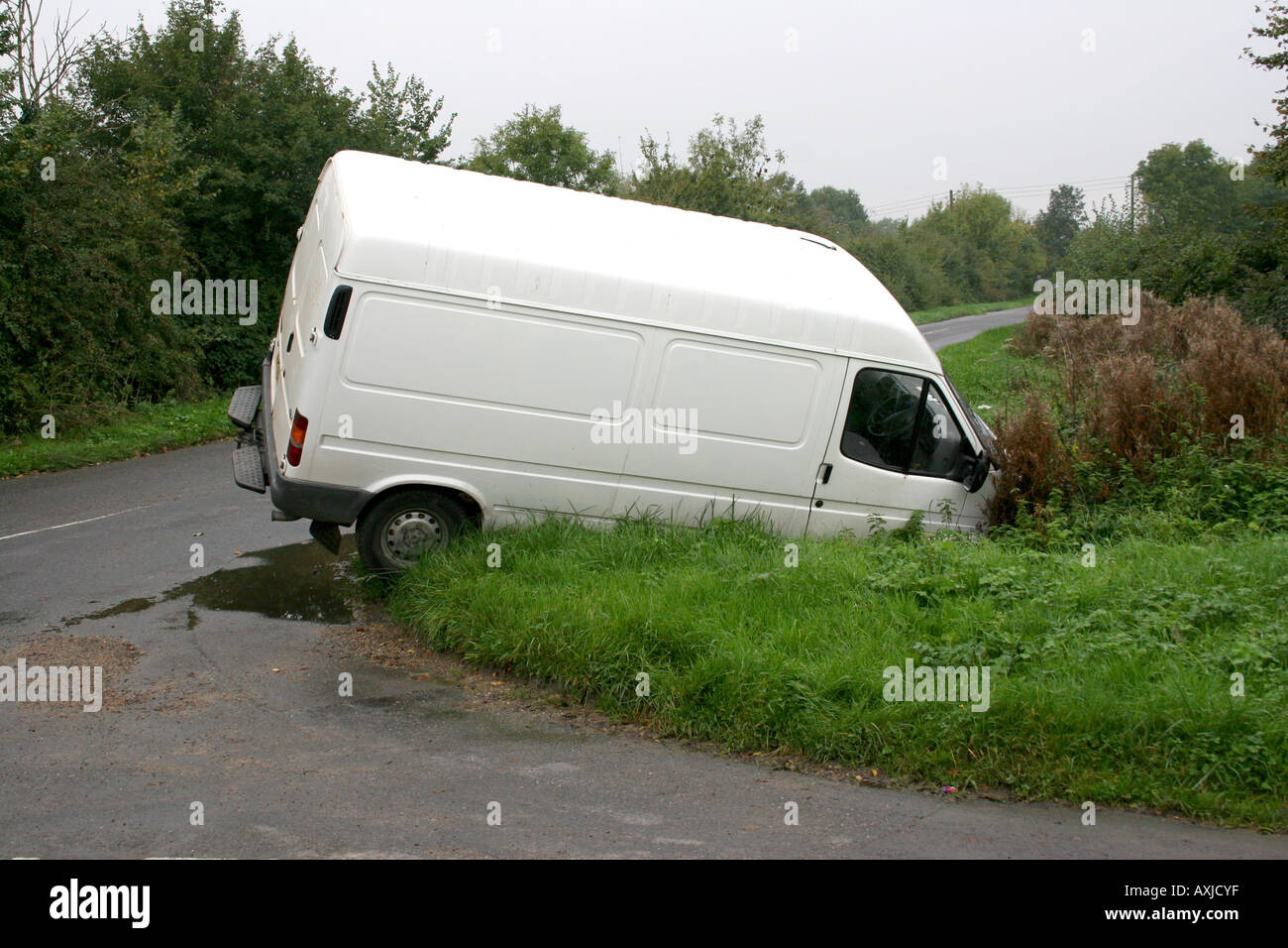 A white van crashed into a ditch Stock Photo - Alamy