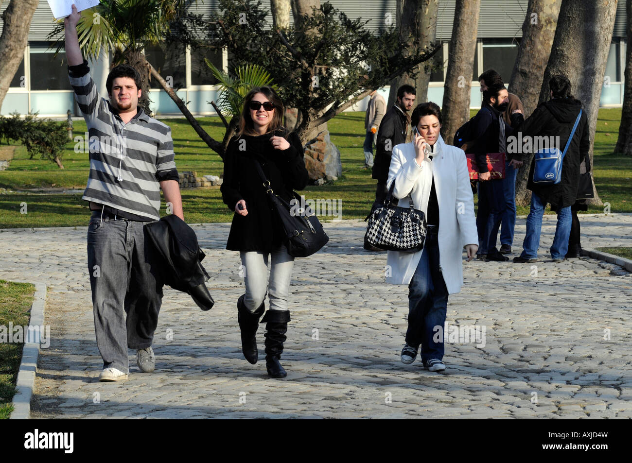 Young fashionable Turkish students walking in their university campus ...