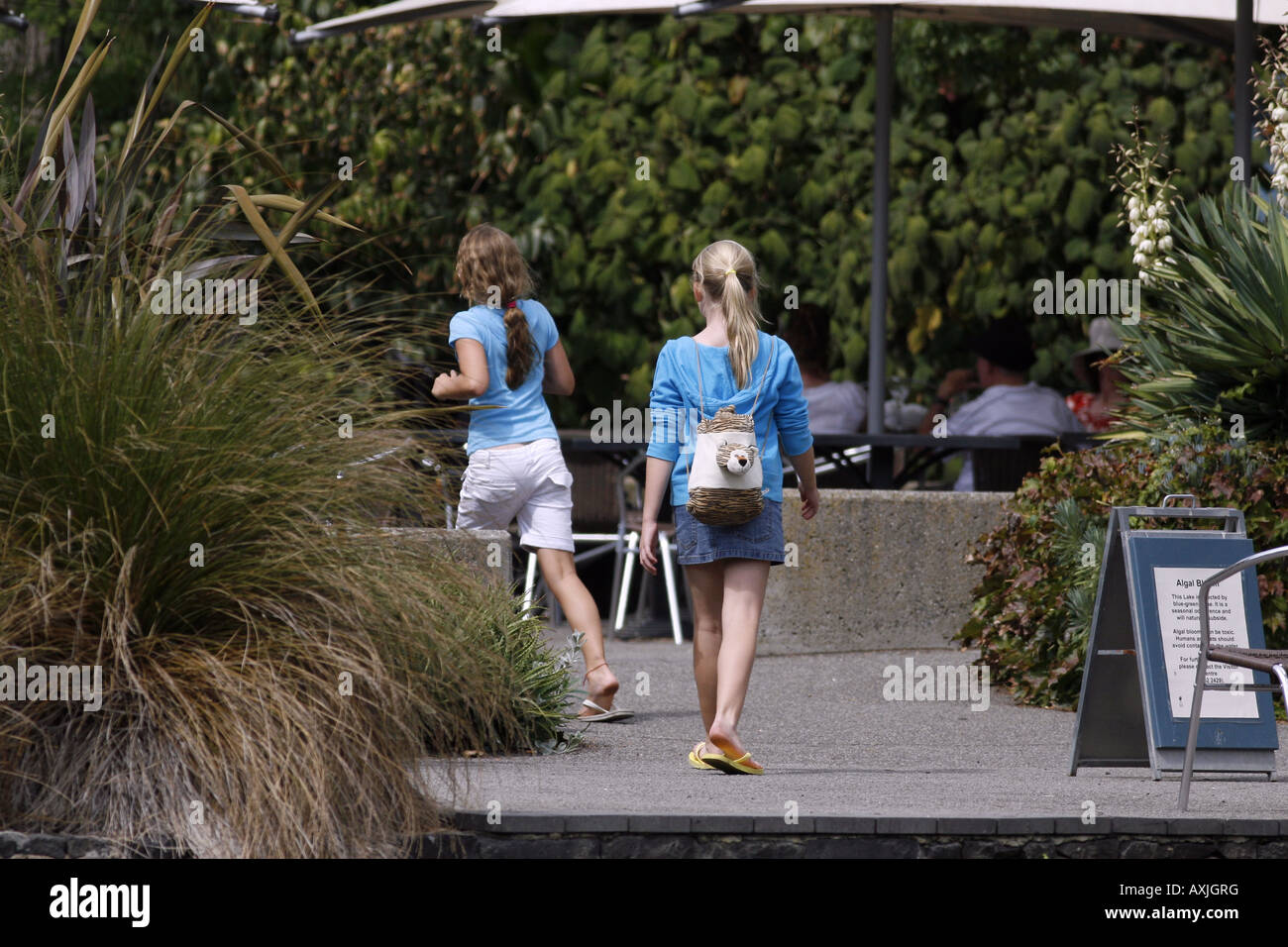 two girls walking in the park in summer afternoon Stock Photo - Alamy