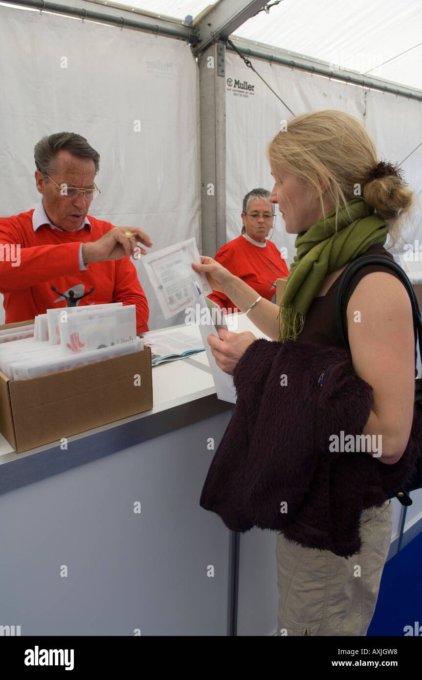 A female runner collects her race number for the Lausanne marathon ...