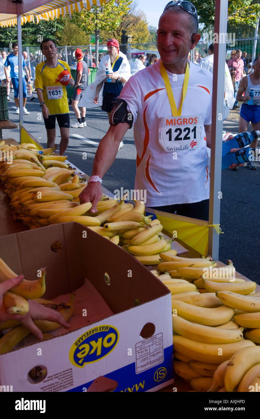 A runner picking up a banana having just finished the Lausanne marathon ...