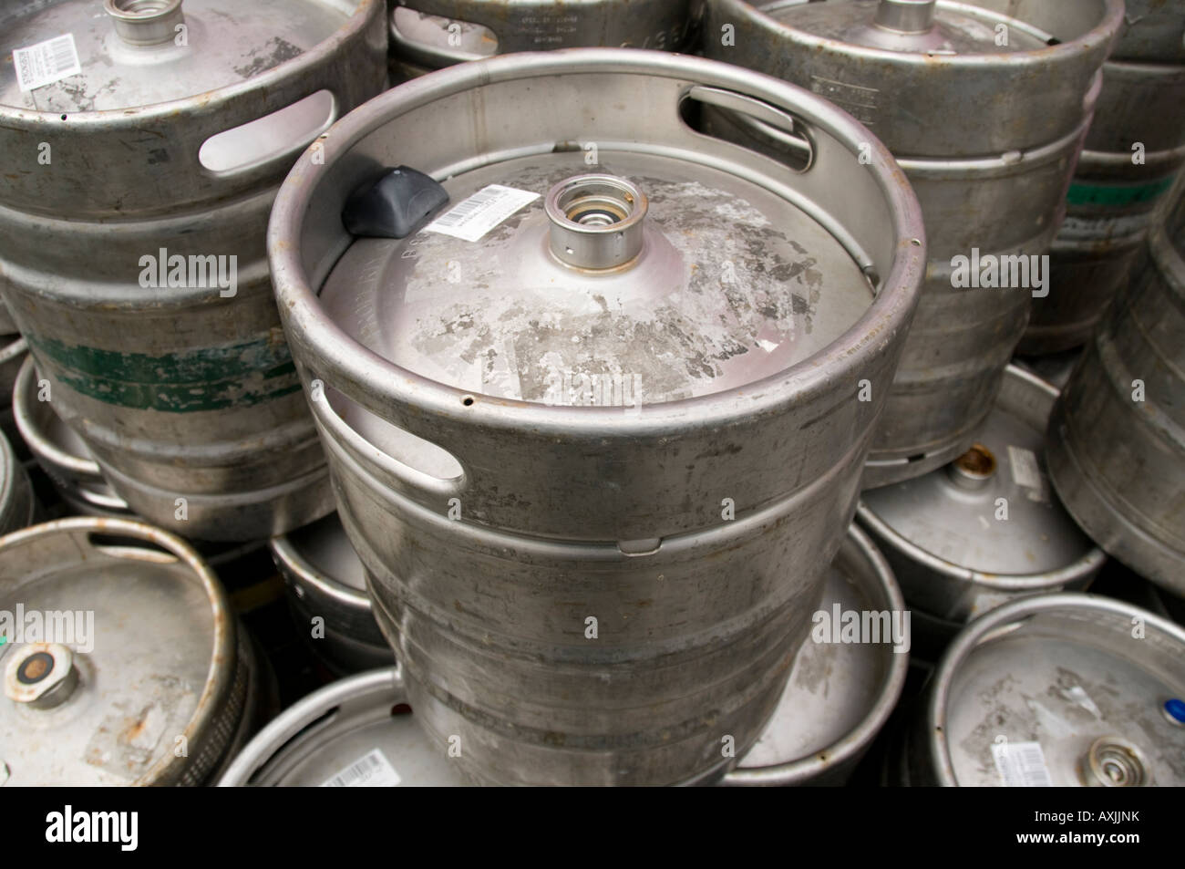 aluminium pressurised beer kegs in a stack outside pub awaiting ...