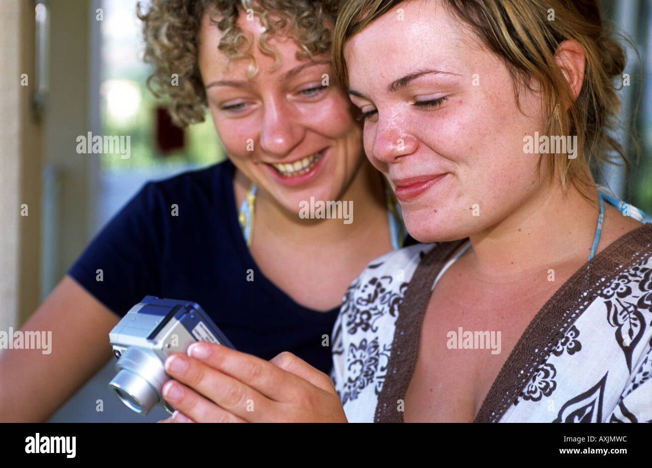Girls viewing pictures on the preview screen of a digital camera Stock ...