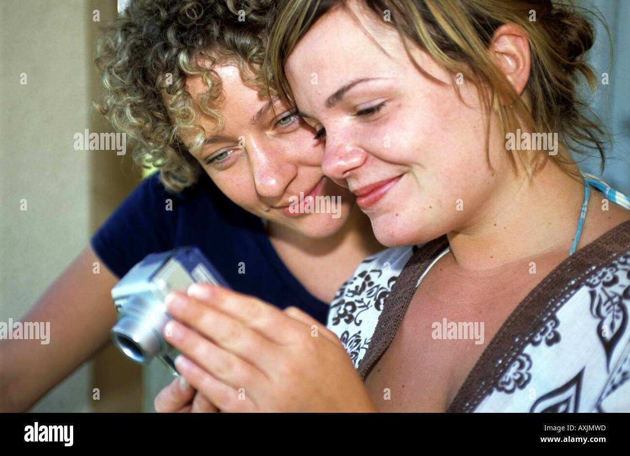 Girls viewing pictures on the preview screen of a digital camera Stock ...