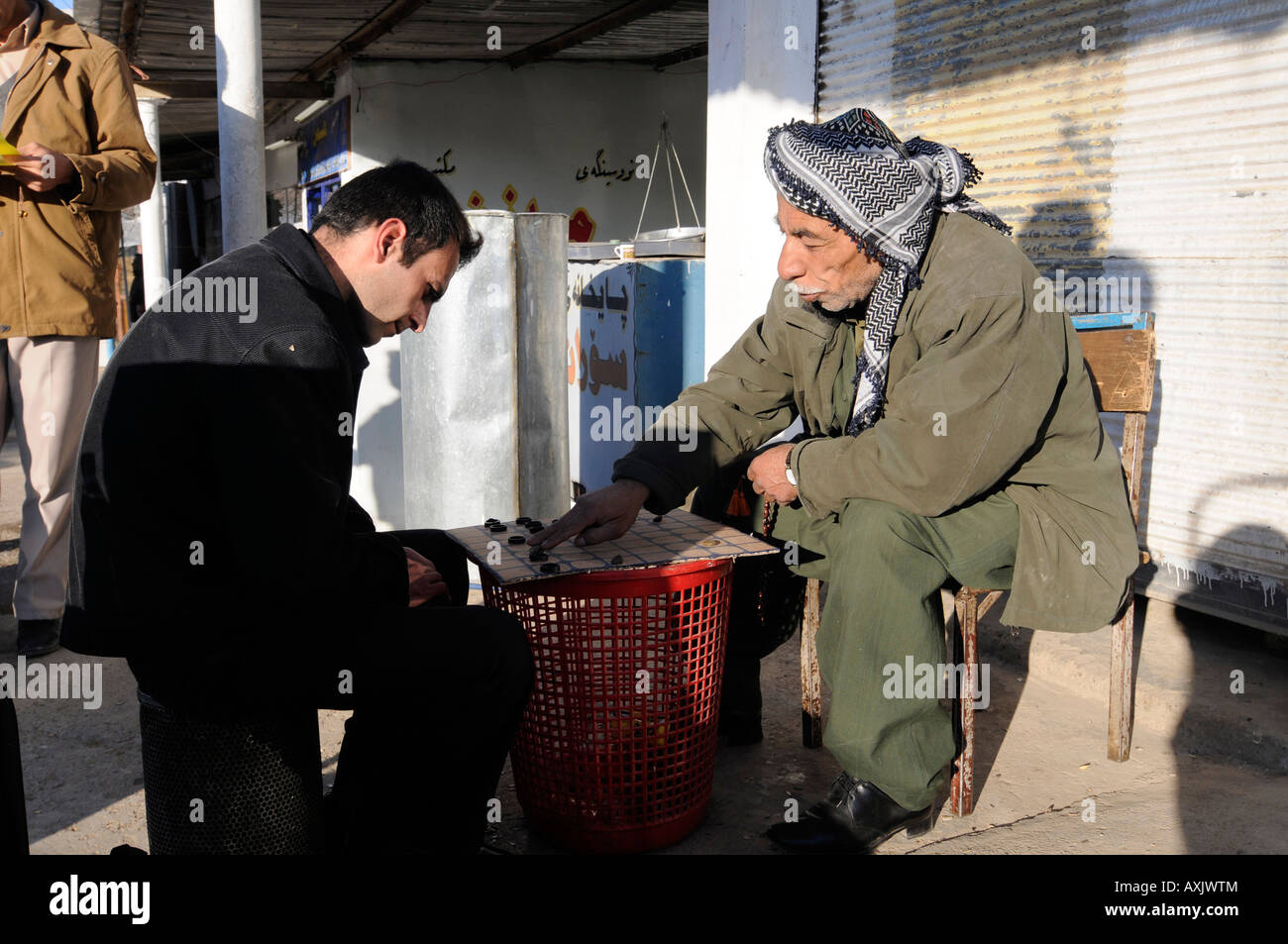Portrait of Kurdish men playing checkers in the street in Iraqi ...