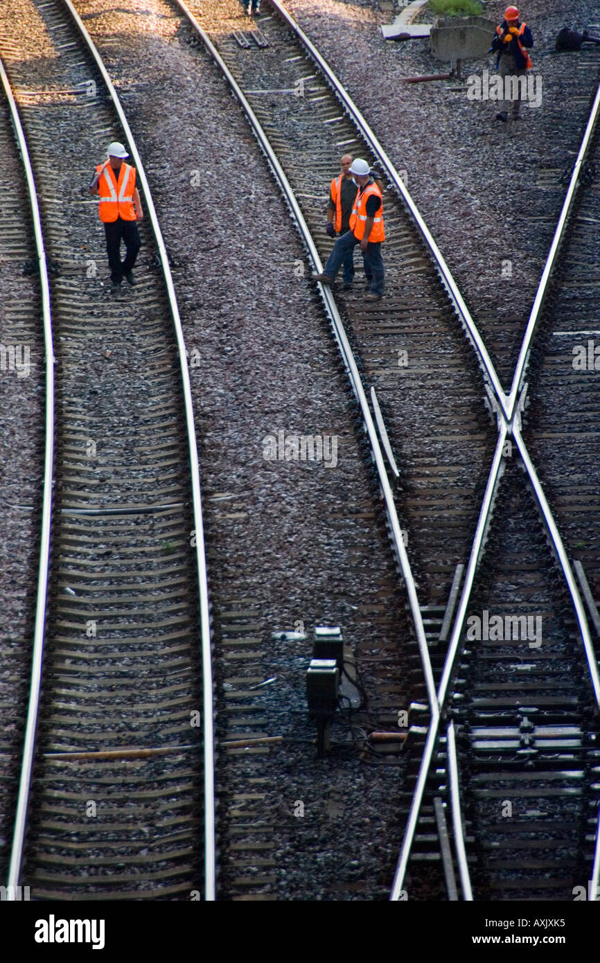 Railroad workers walking on converging railroad tracks Stock Photo - Alamy