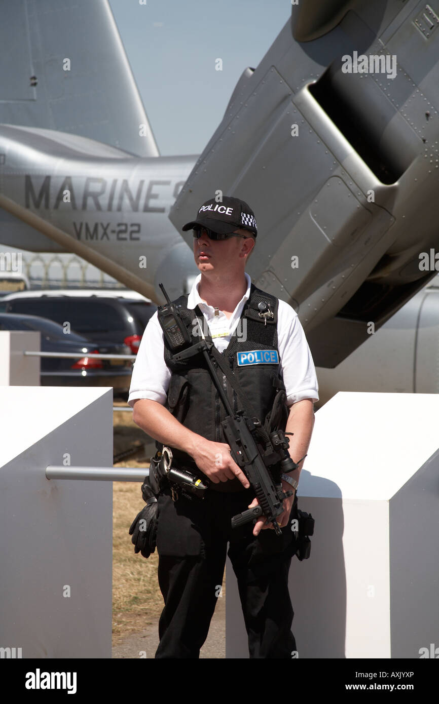 On guard Armed policeman in front of Bell Boeing V 22 Osprey aircraft ...