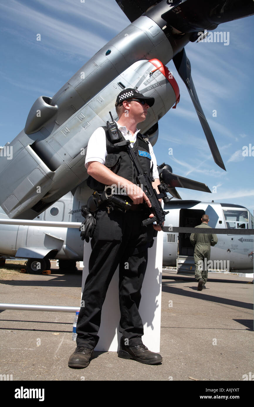 On guard Armed policeman in front of Bell Boeing V 22 Osprey aircraft ...