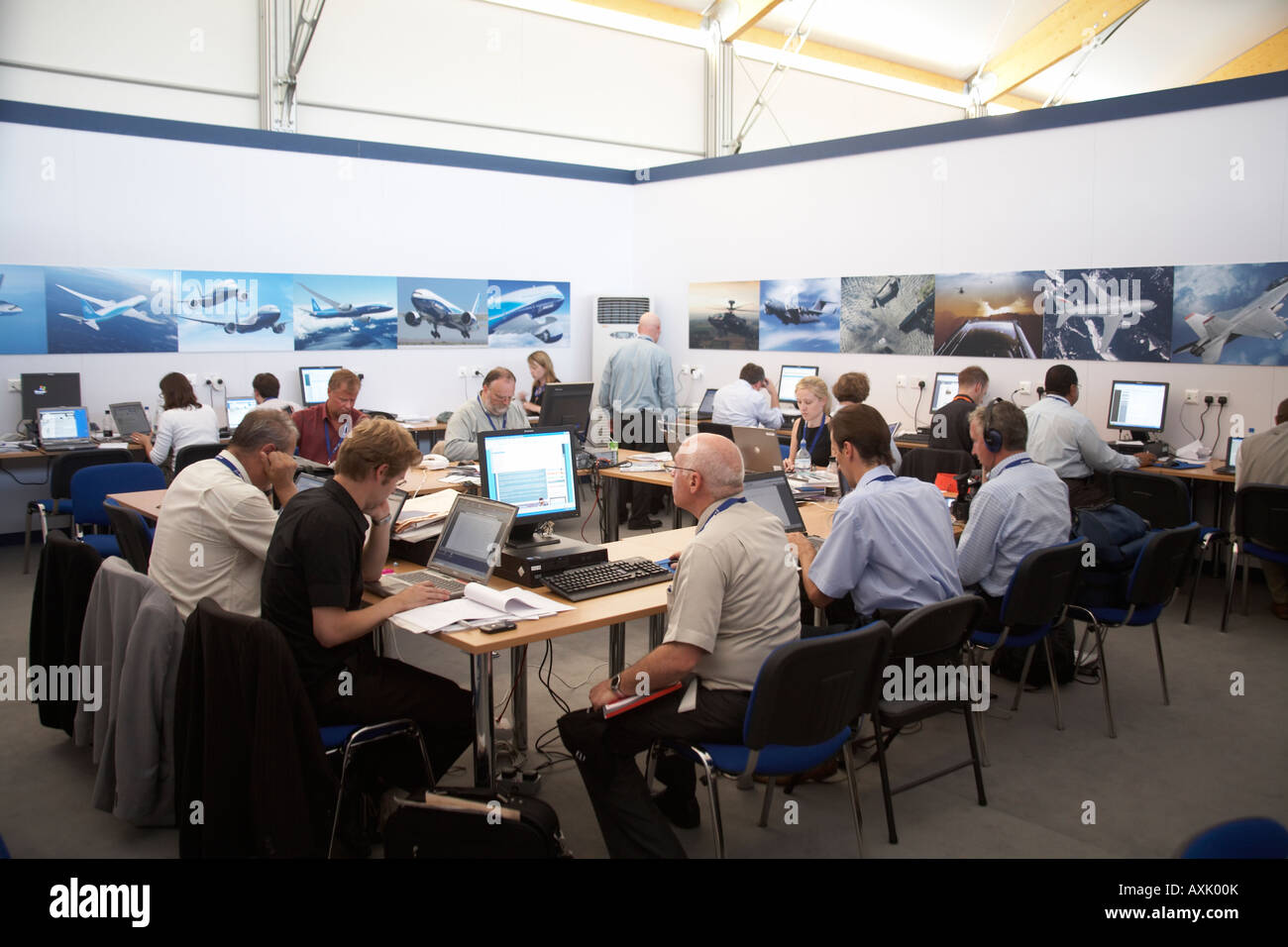 Journalists at work on their computers in communications centre at ...
