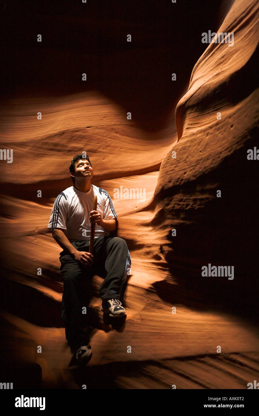 man person sitting listening in light on rock with whistle shadows dark ...