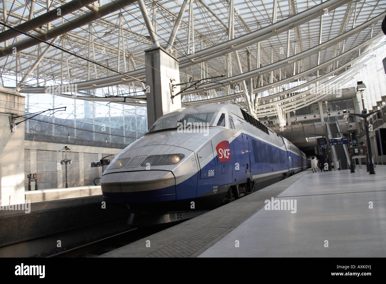 SNCF train approaching with passengers platform in TGV railway station ...