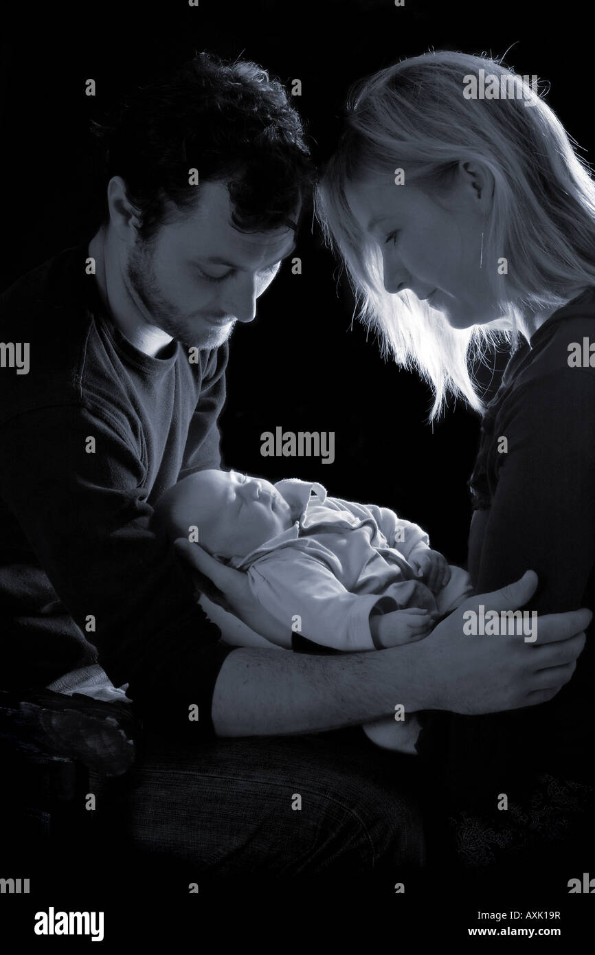 Loving couple admiring their newborn little baby Stock Photo - Alamy