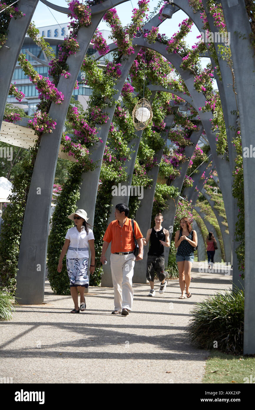 Sculptural contemporary Arbour walkway with people and bougainvilla on ...