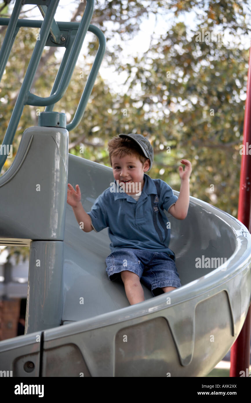 Young boy child sliding down slide on South Bank in Brisbane Queensland ...