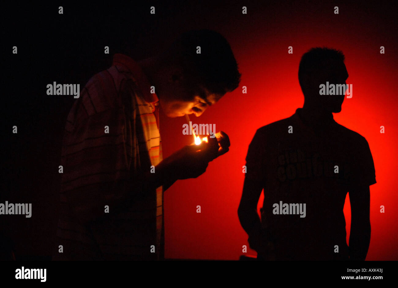 Man lighting a cigarette Stock Photo - Alamy