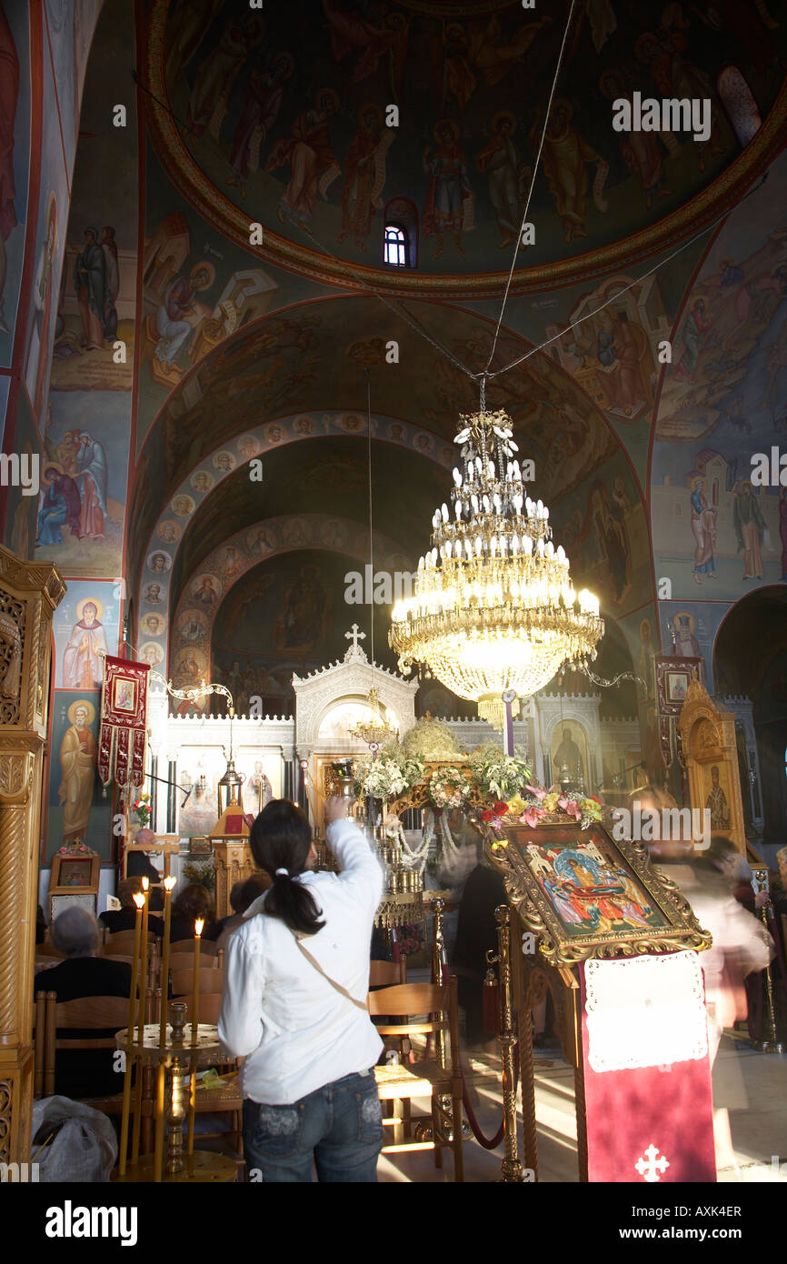 Worshipper woman llighting candle before Easter Good Friday evening ...