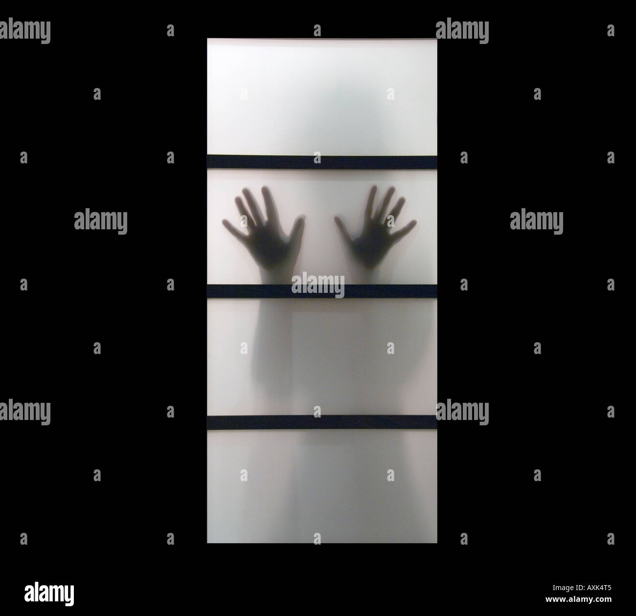 female figure trapped behind a barred frosted glass window with a black ...