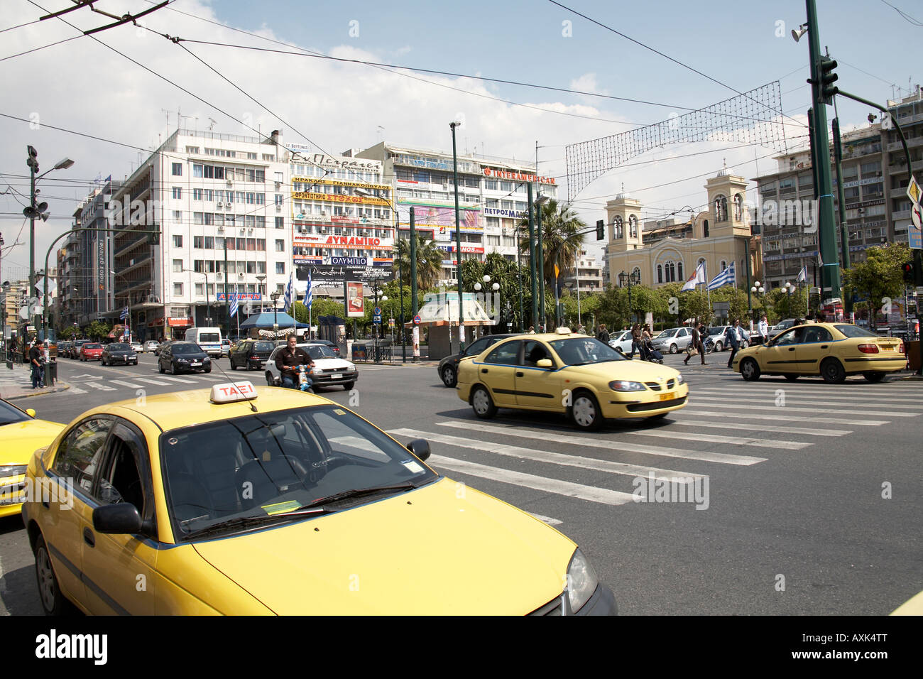 Korai Square with yellow taxis on zebra crossing and tramlines in ...