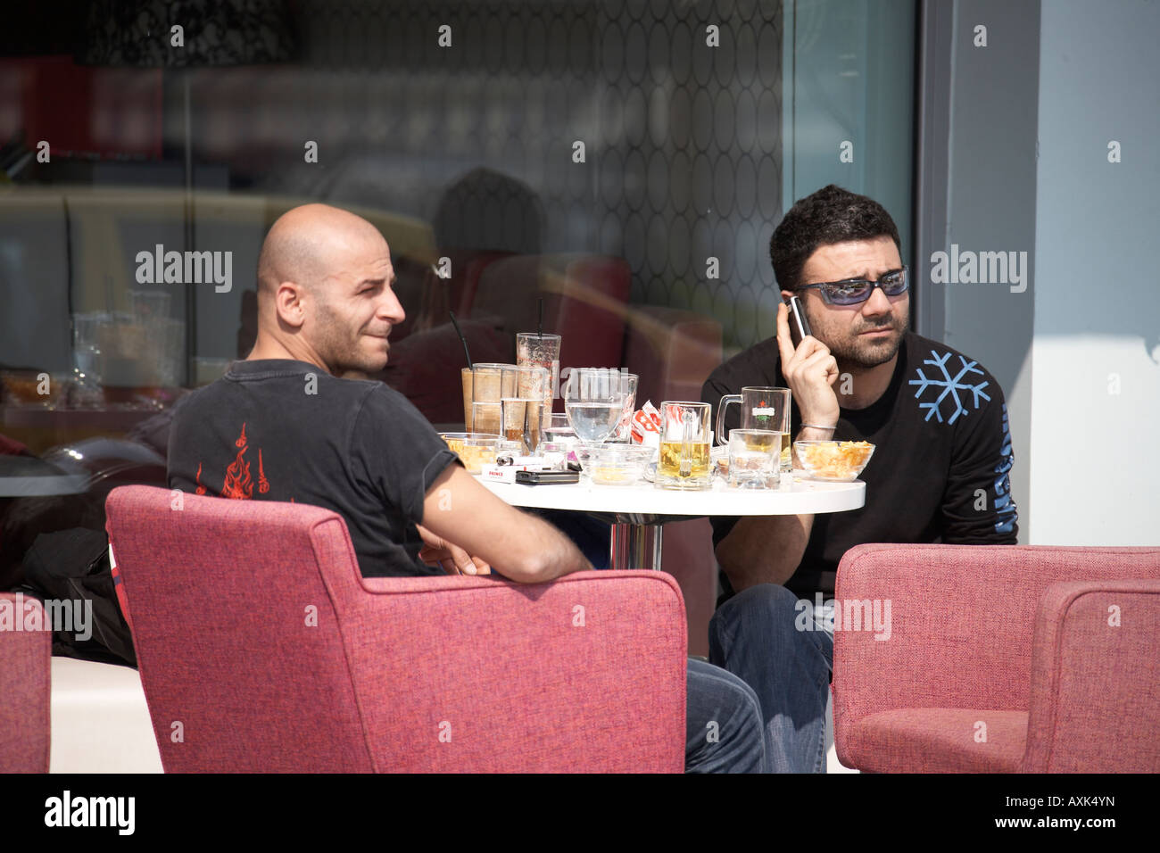 Cafe with two men drinking in Mikrolimano or Tourkolimano old small ...