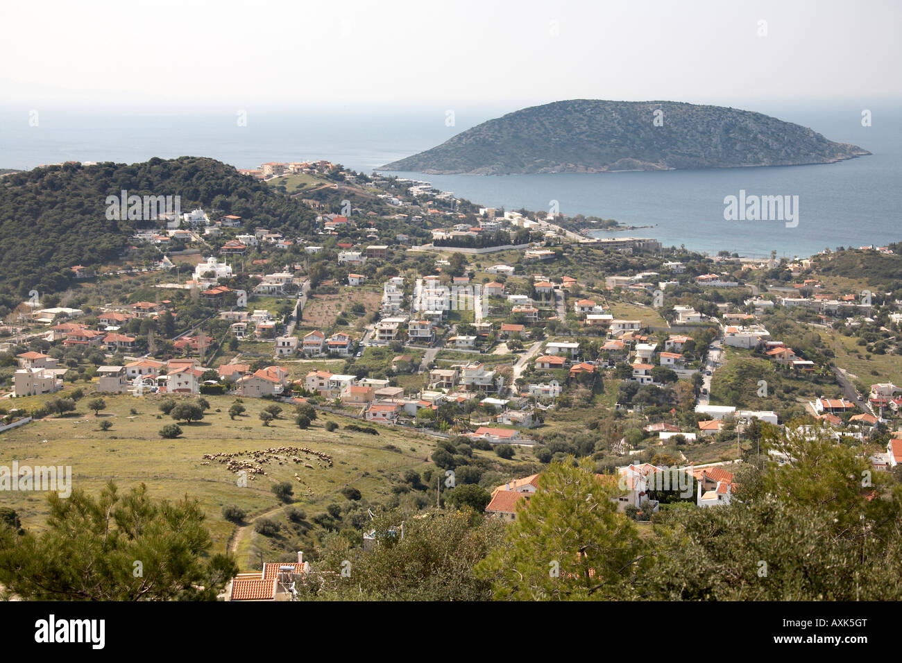 Houses on hillside and island in the sea from hill above Saronida in ...