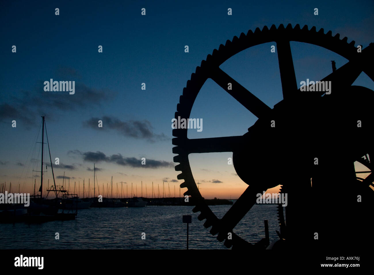 silhouettes af gear machine, sunset over sea Stock Photo - Alamy
