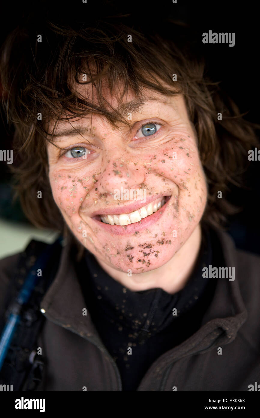smiling woman mountain biker with mud spattered face Stock Photo - Alamy