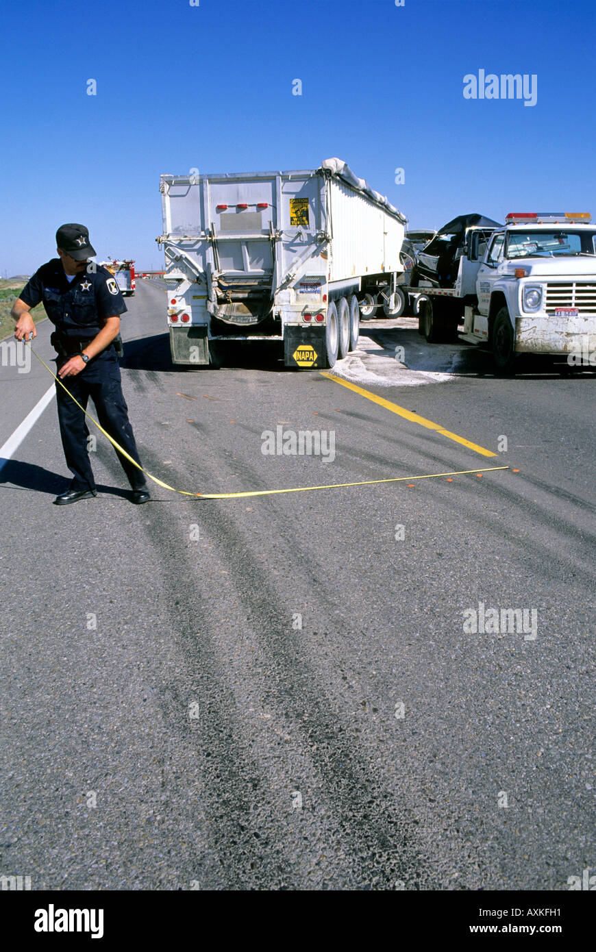 Police investigate traffic accident and measure skid marks from tires ... Police investigate traffic accident and measure skid marks from tires ...